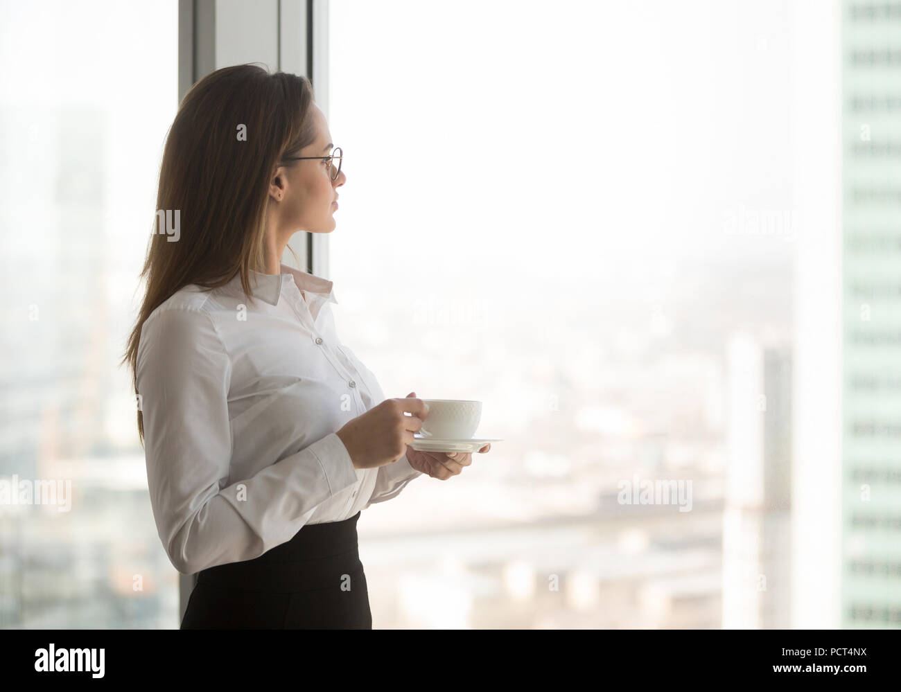 Thoughtful ceo enjoying view from window drinking coffee Stock Photo ...