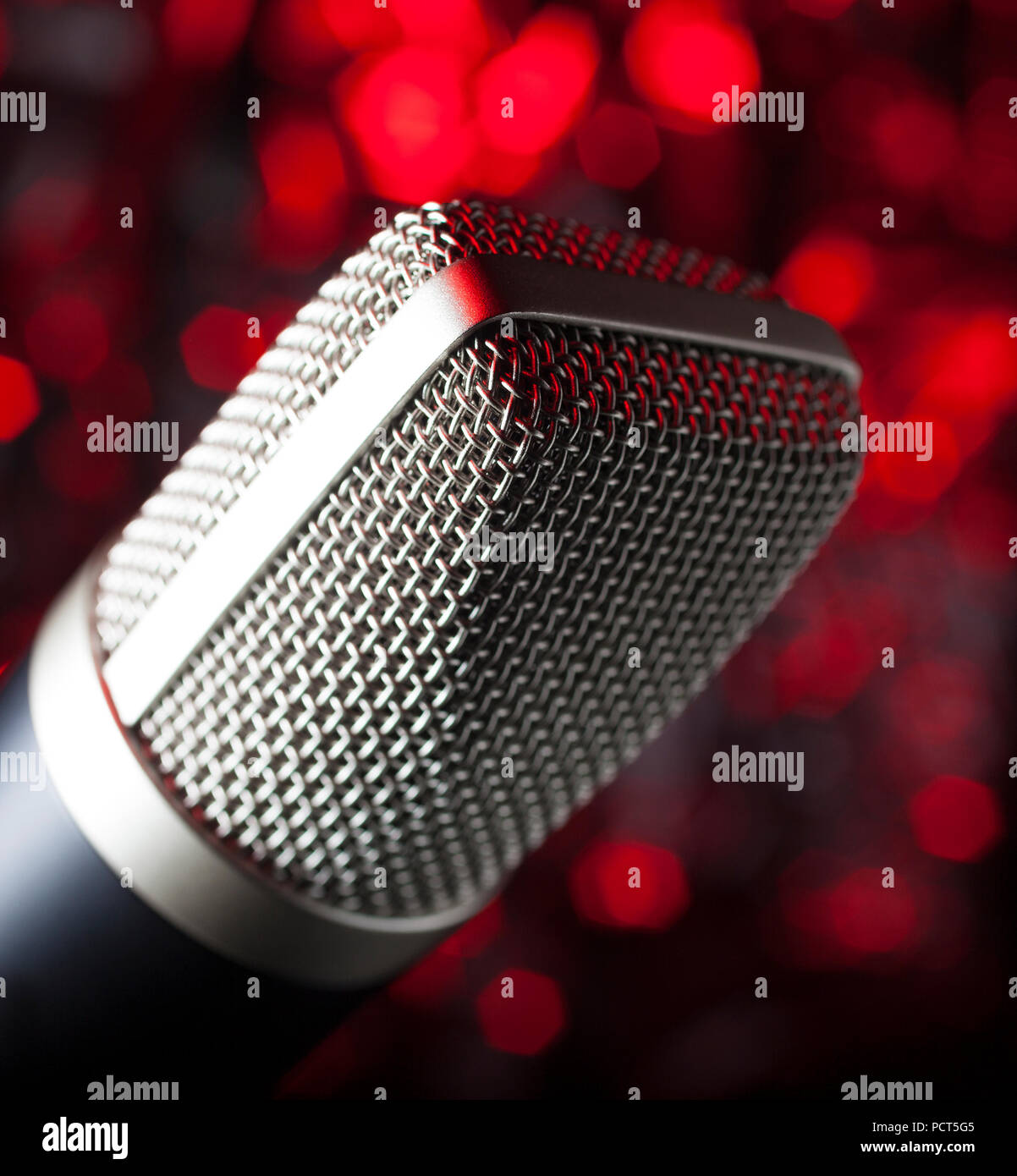 Microphone with wire mesh and a red background Stock Photo - Alamy