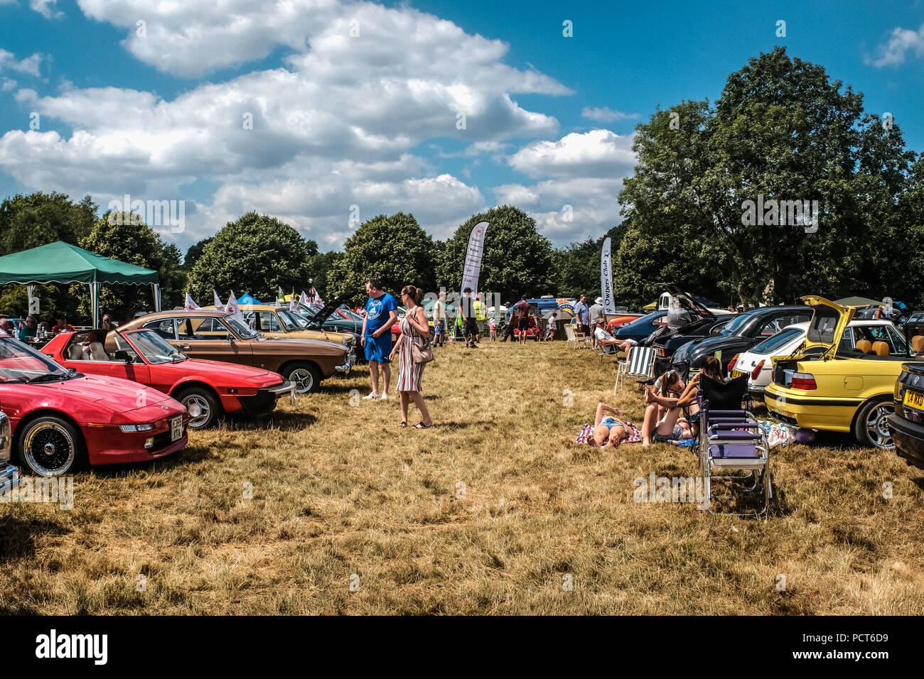 Family day out at a classic car show held at the historic manor house ...