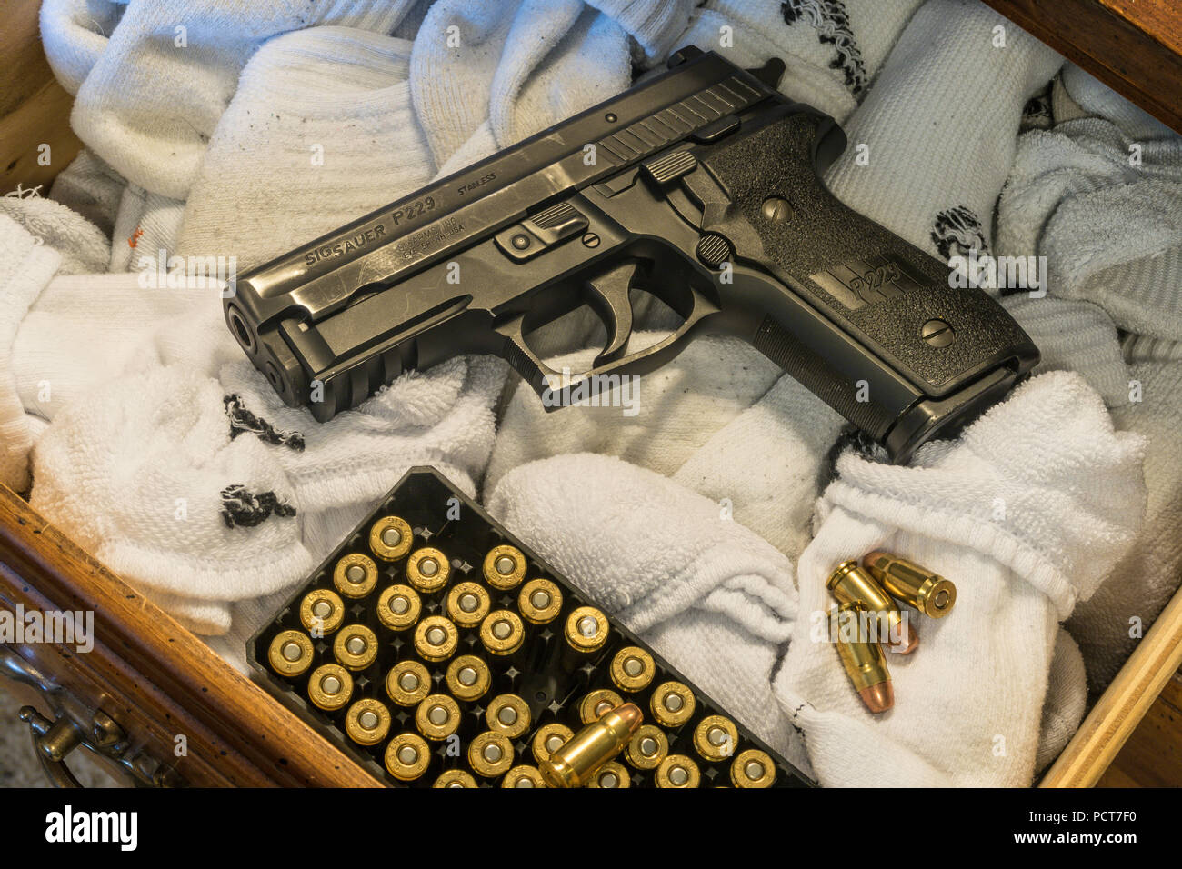 Semi-automatic pistol in sock drawer, USA Stock Photo - Alamy