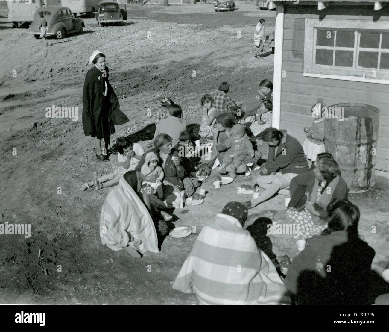 Native Americans Sit on Ground Eating While Woman Looks On ca 1938 ...