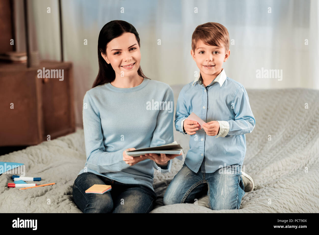 Pleasant positive mother and son looking at you Stock Photo - Alamy