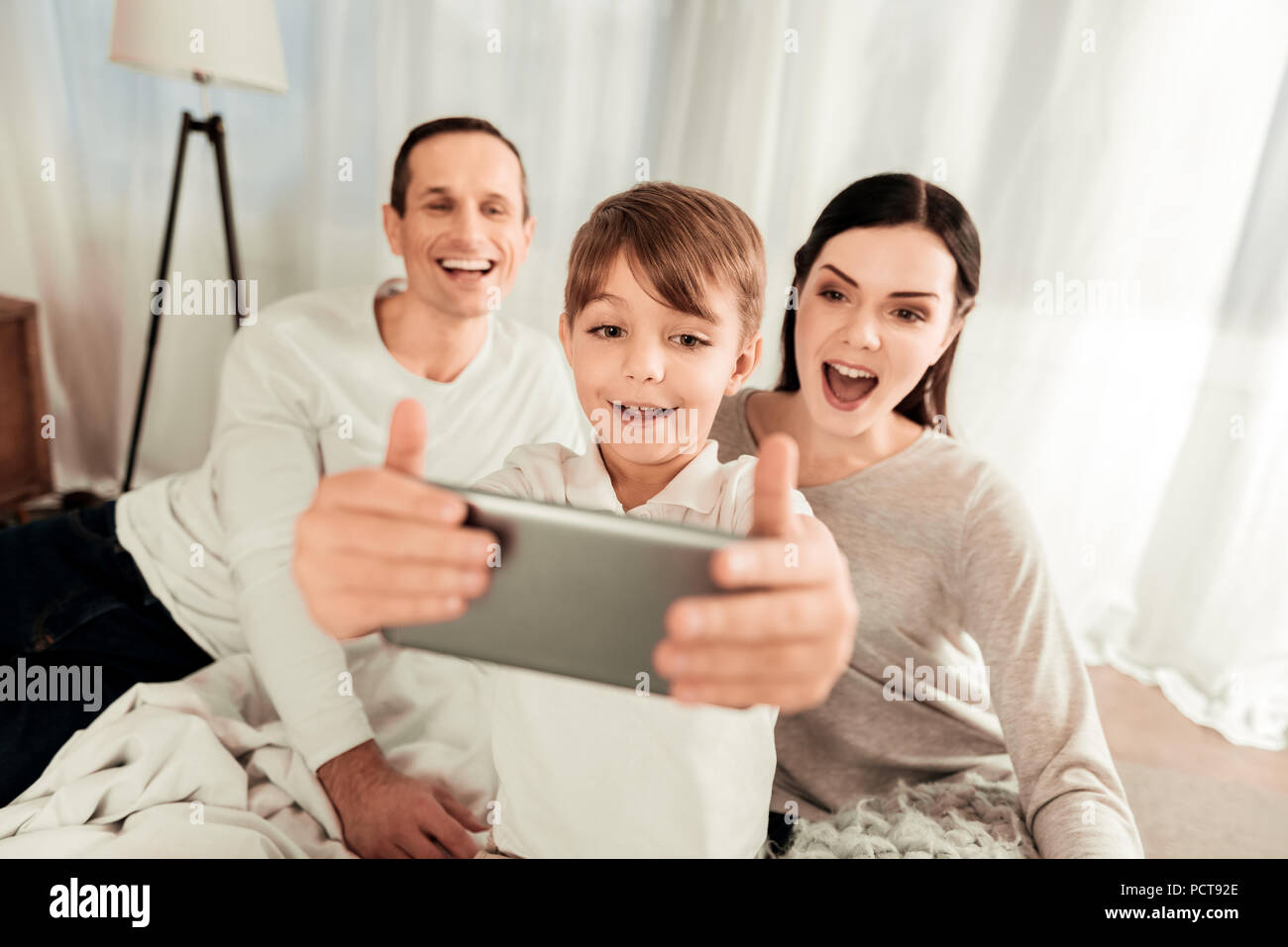 Pleasant happy family posing for a photo Stock Photo - Alamy