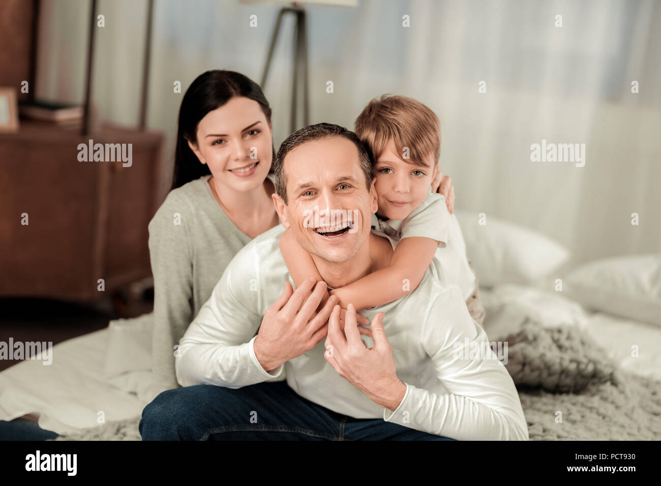 Positive nice boy hugging his father Stock Photo - Alamy