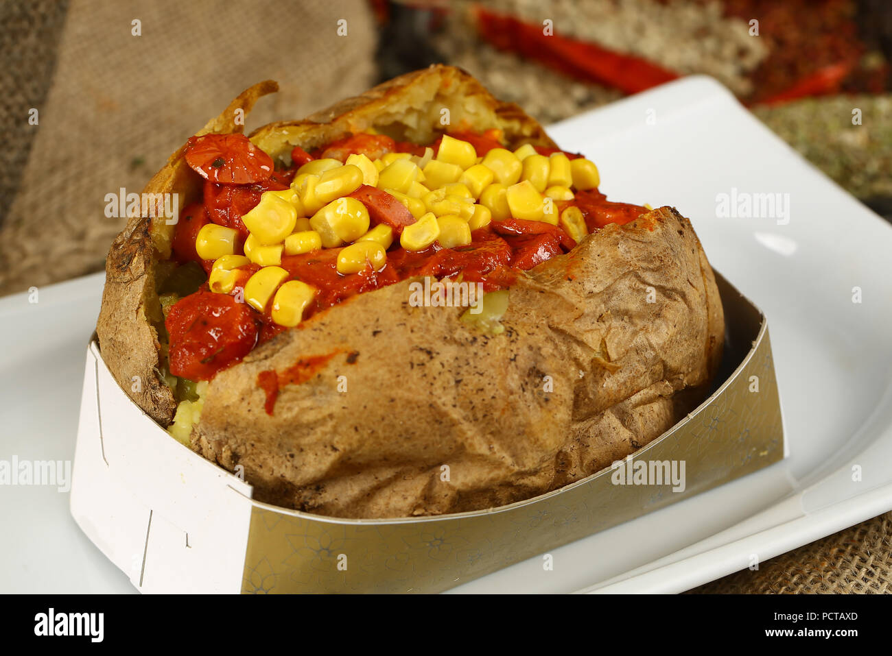 Kumpir, Turkish Baked potato with cheese, corn and sausage Stock Photo ...