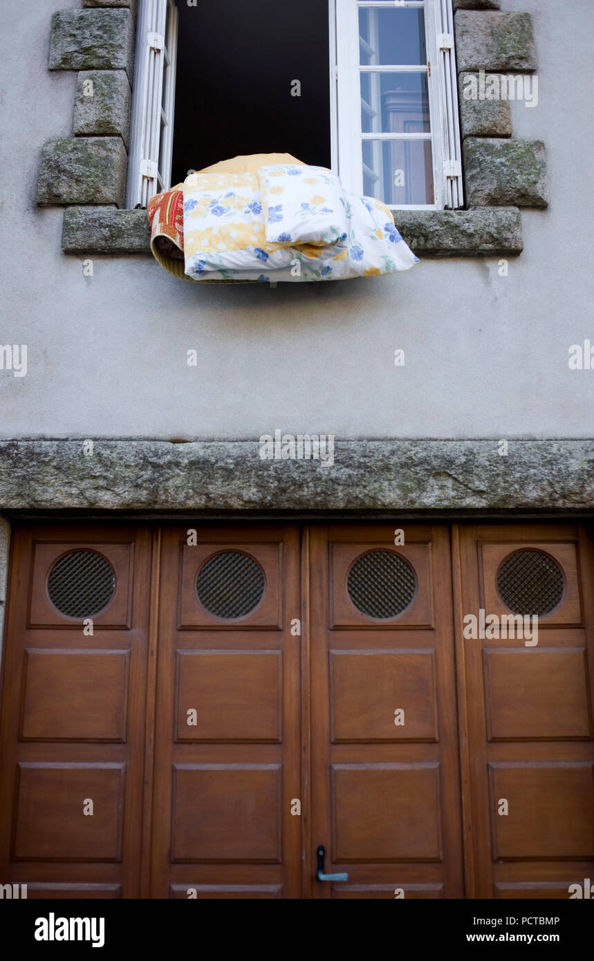 Sheets hanging out of the window Stock Photo - Alamy