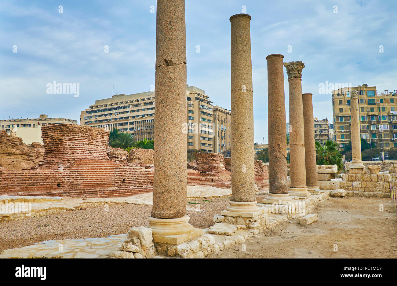 The ancient street of Kom Ad Dikka archaeological site with tall stone ...