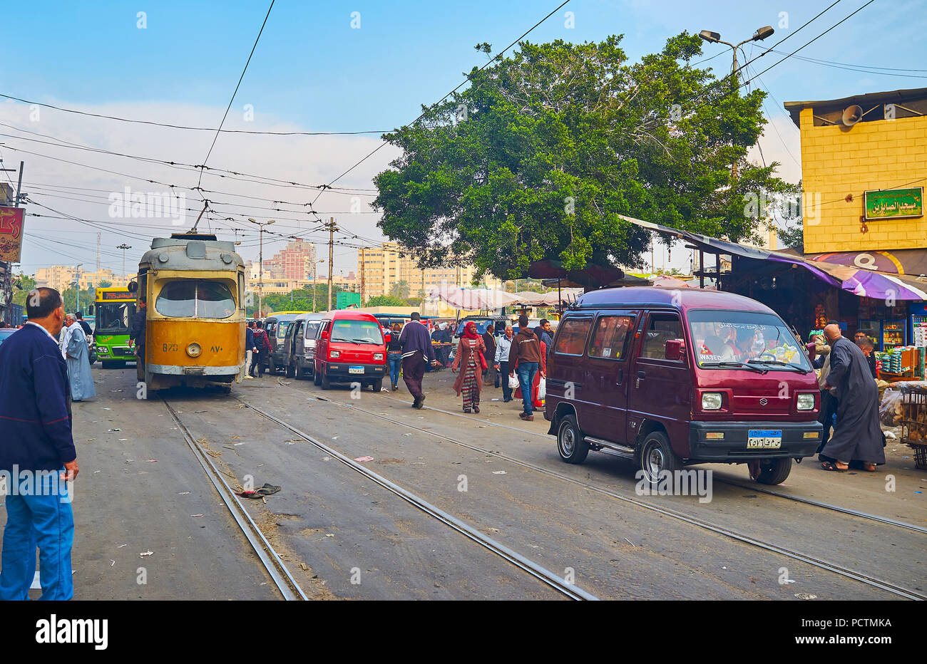 ALEXANDRIA, EGYPT - DECEMBER 18, 2017: The old yellow tram rides along ...