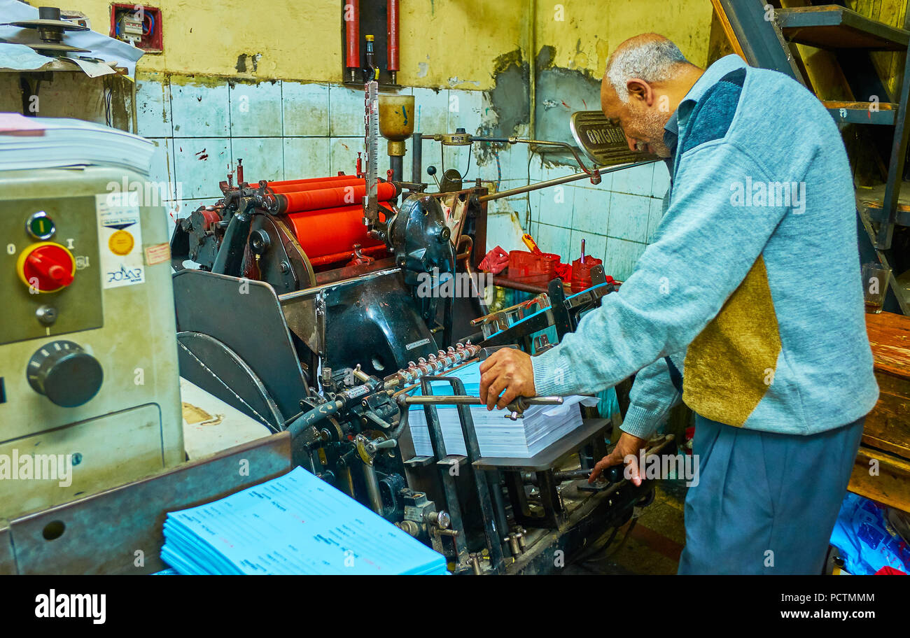 ALEXANDRIA, EGYPT - DECEMBER 18, 2017: The man works on the printing ...