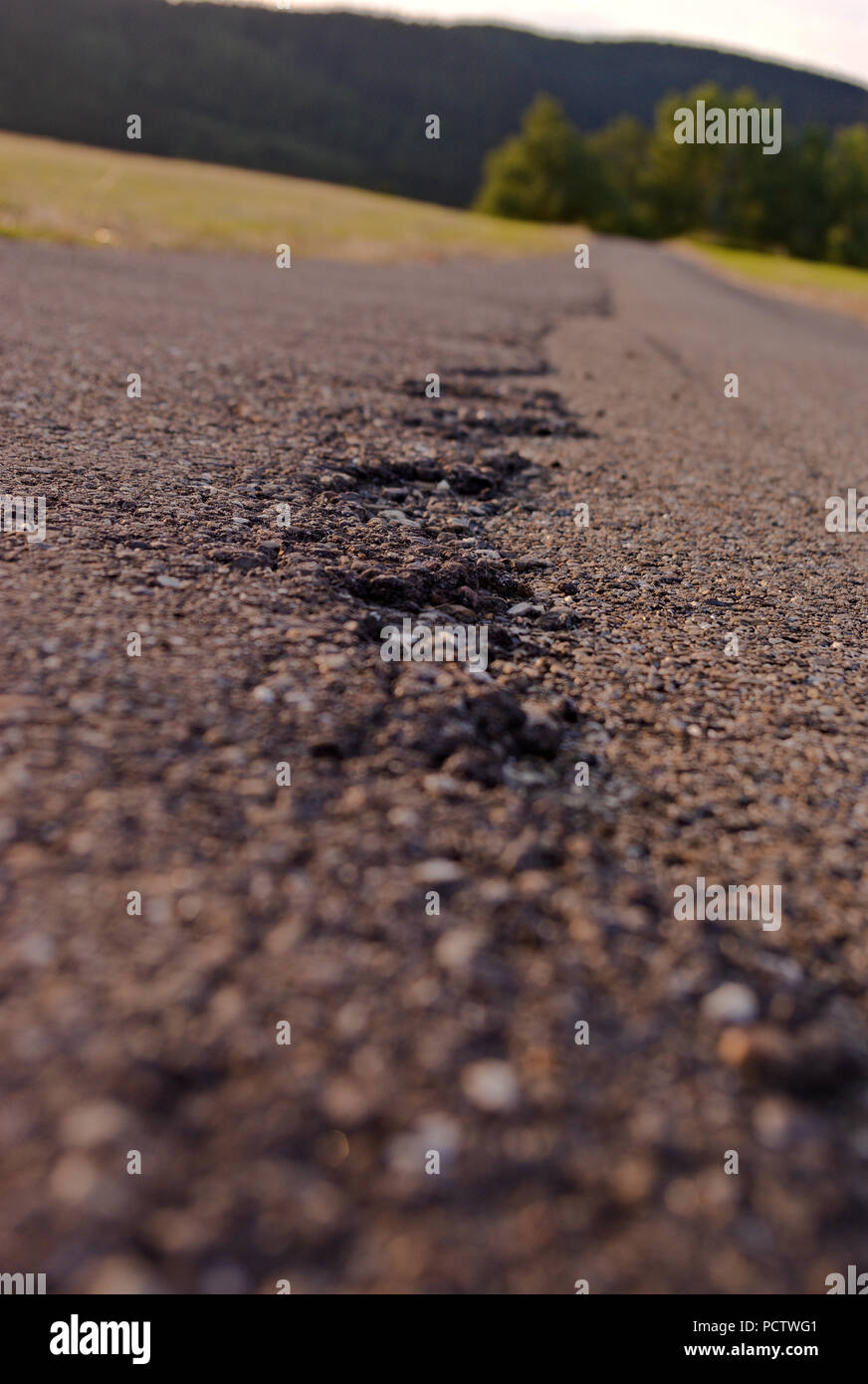 seam where asphalt is joined on a countryside road. Detail macro shot ...