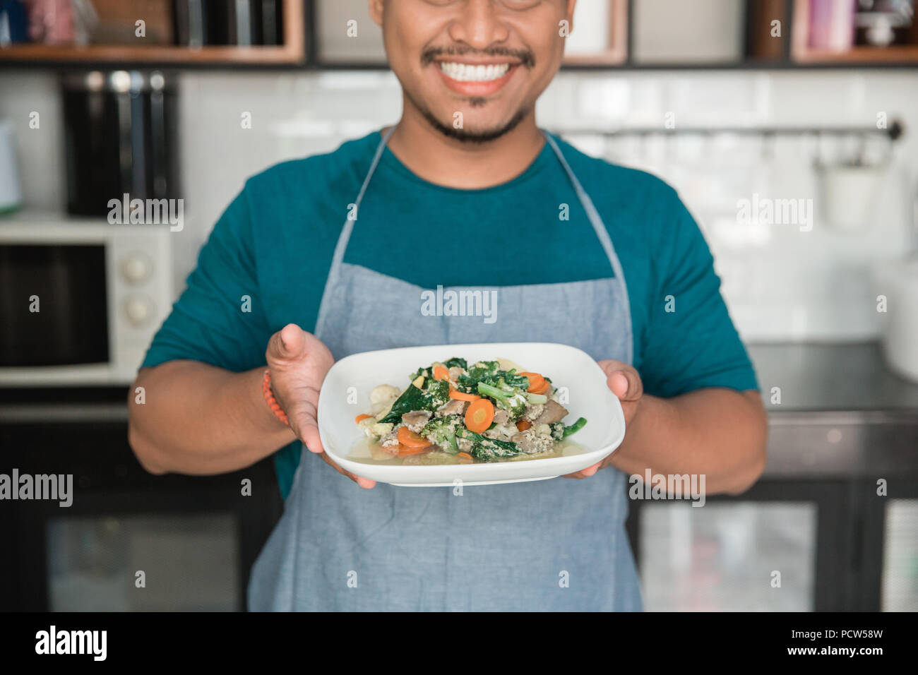 Asian man carrying food hi-res stock photography and images - Alamy