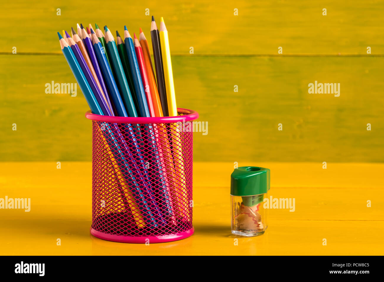 color pencils in metal grid container on the yellow board Stock Photo ...