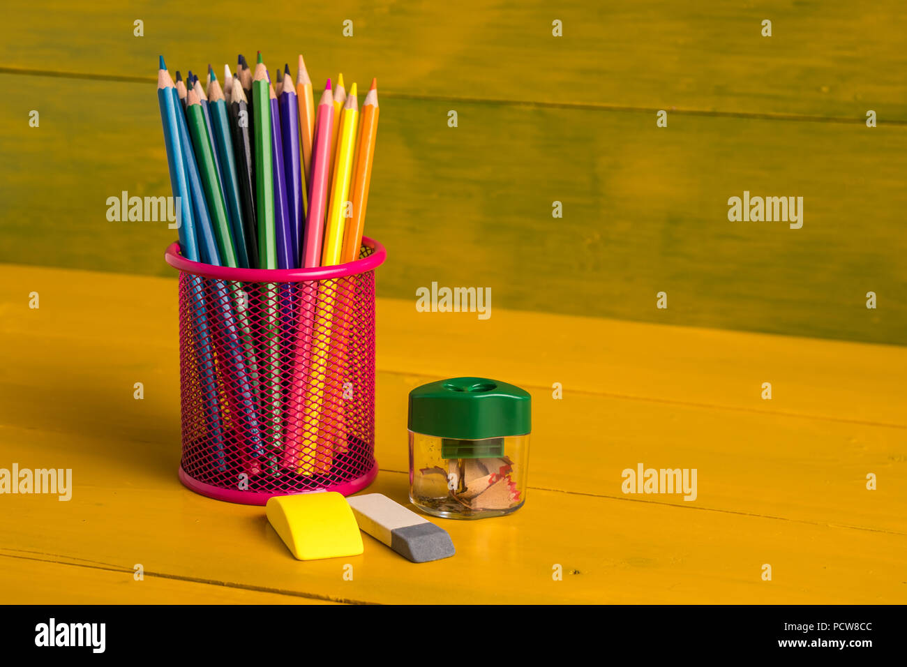 color pencils in metal grid container on the yellow board Stock Photo ...