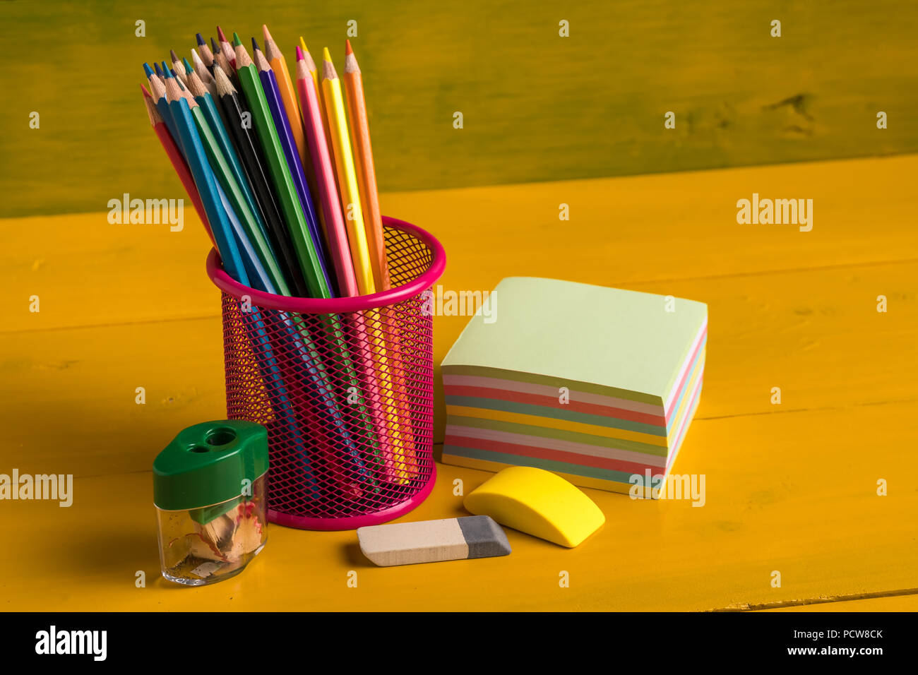 color pencils in metal grid container on the yellow board Stock Photo ...