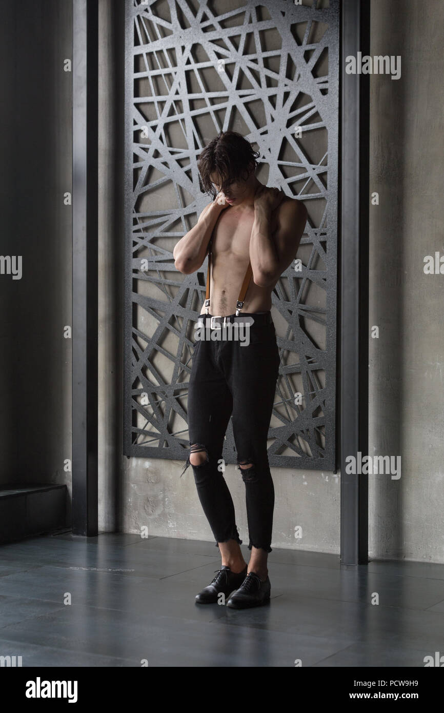 Shirtless male model with dark hair looking over his shoulder Stock ...
