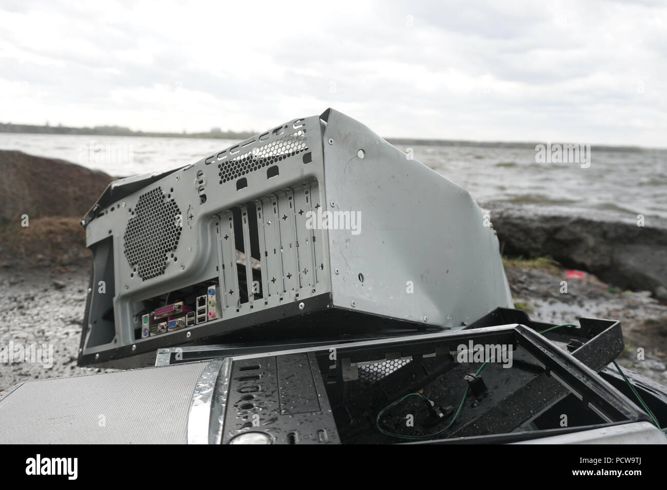 Man breaks a hammer system unit computer. Man with a sledge hammer and ...