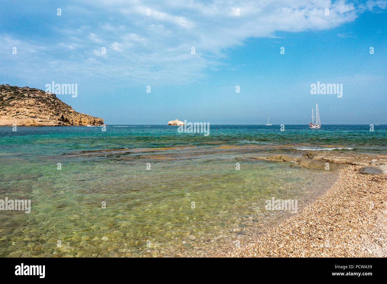 Pebble beach and blue sky in Cala Portixol, Costa Blanca, Spain Stock ...