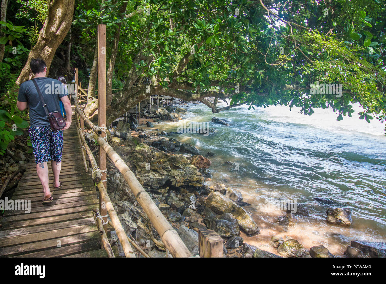 Cliffside wooden path over the water from Ao Nang beach to secluded ...
