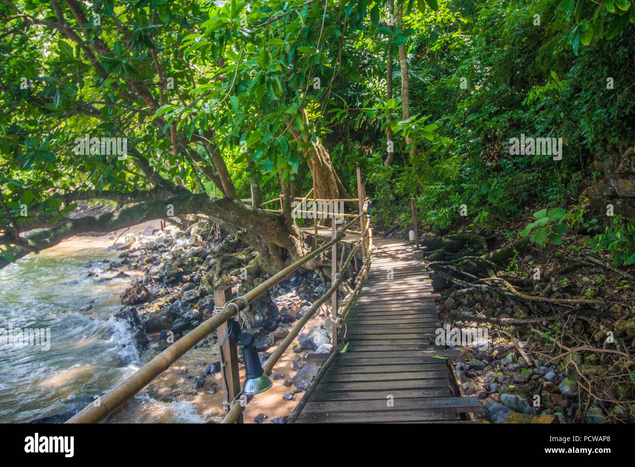 Cliffside wooden path over the water from Ao Nang beach to secluded ...
