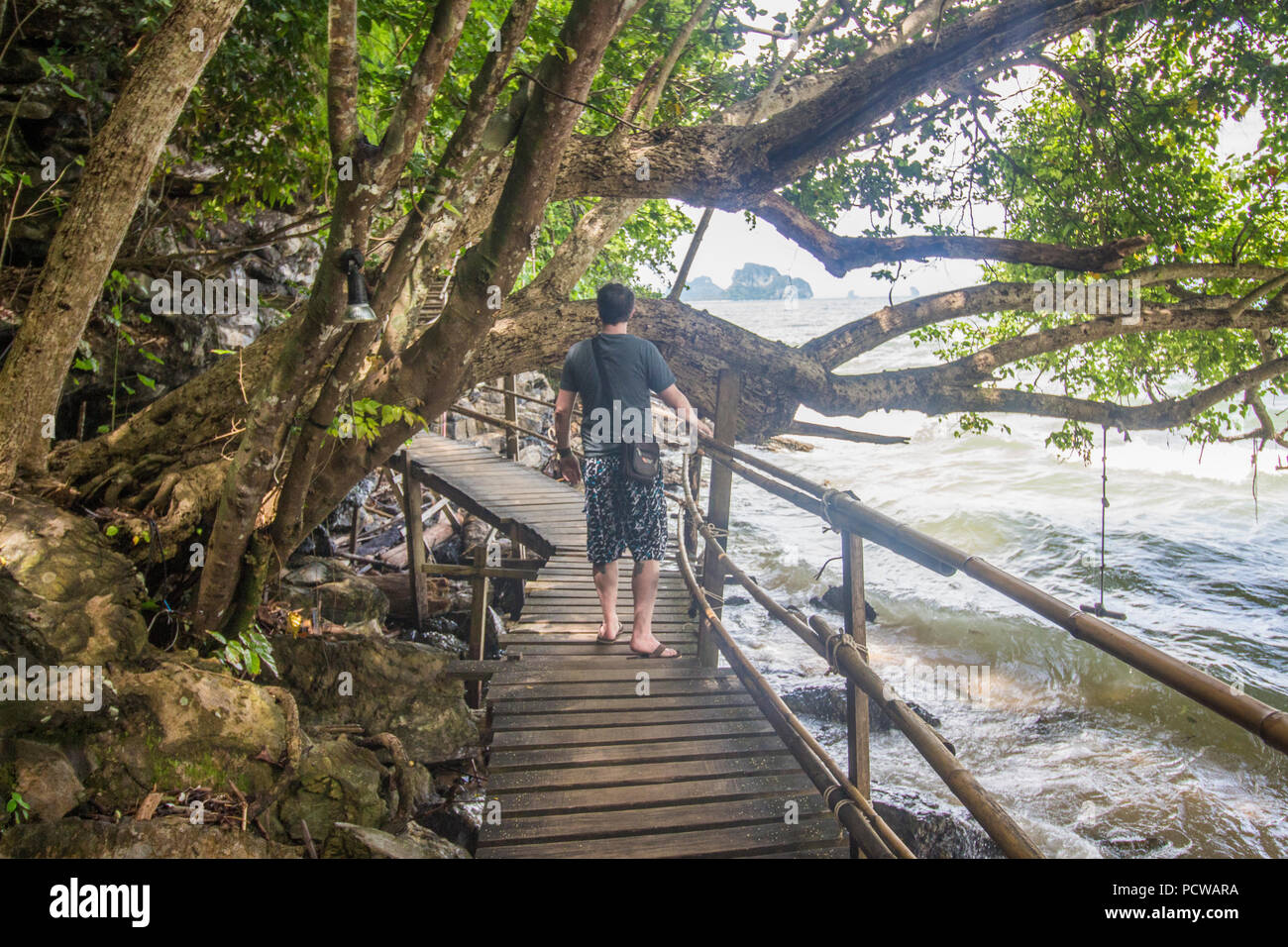 Cliffside wooden path over the water from Ao Nang beach to secluded ...