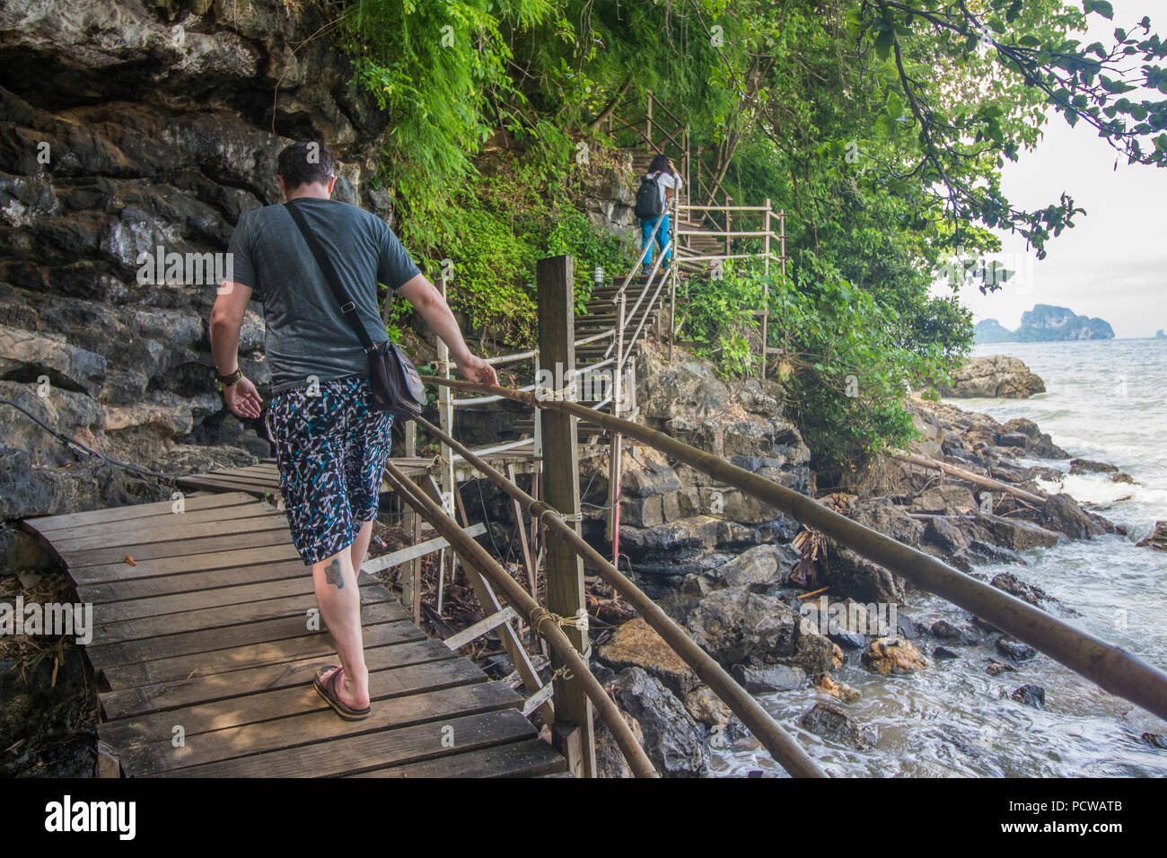 Cliffside wooden path over the water from Ao Nang beach to secluded ...