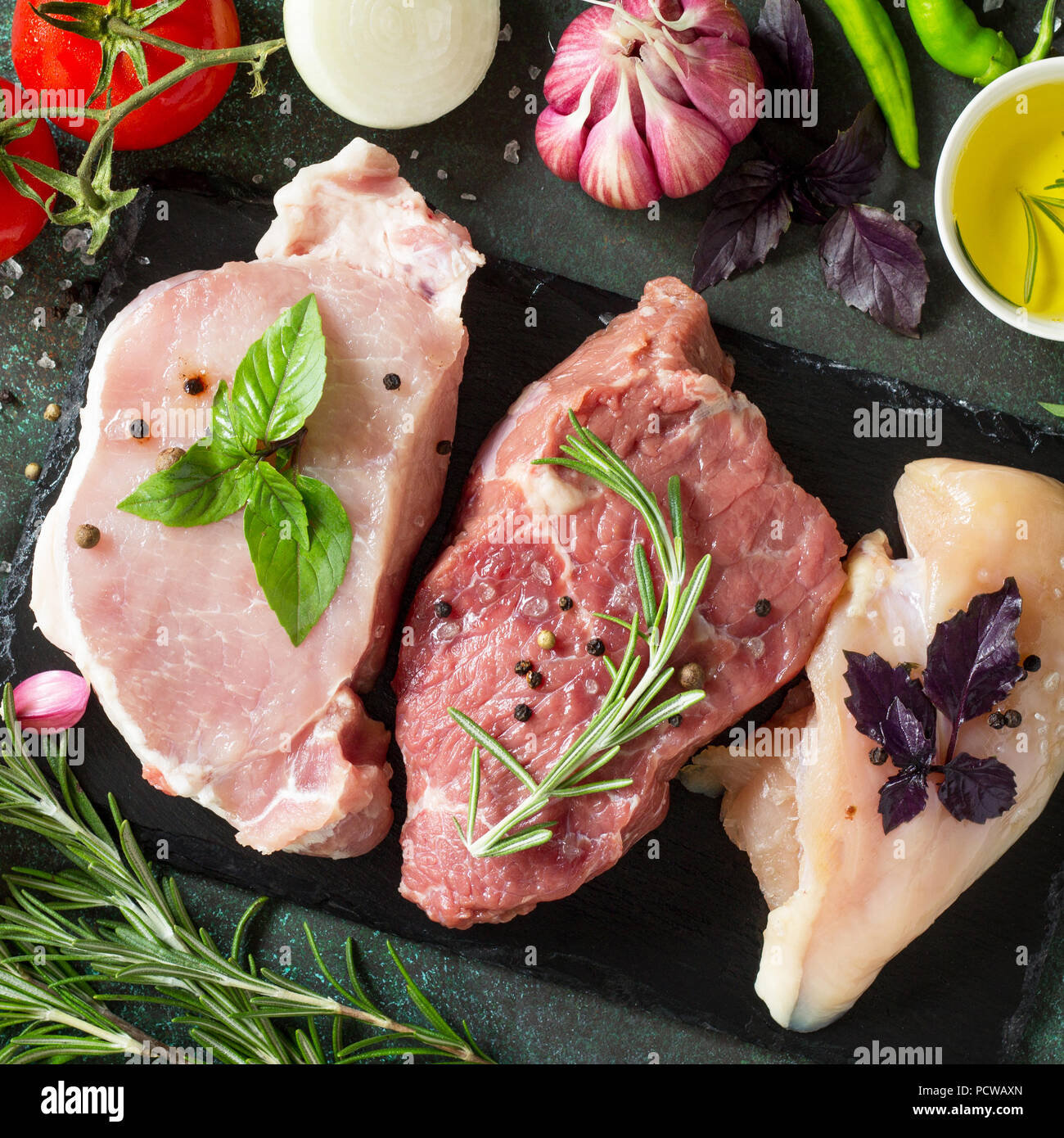 Fresh raw meat. Different types of raw pork meat, chicken fillet and ...