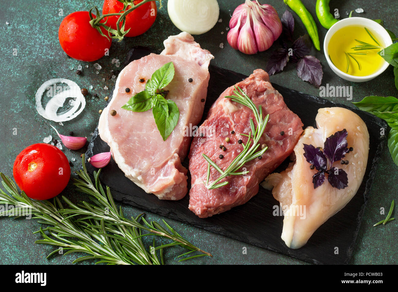 Fresh raw meat. Different types of raw pork meat, chicken fillet and ...