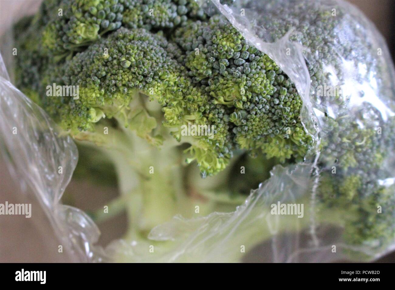 Broccoli wrapped in plastic Stock Photo - Alamy