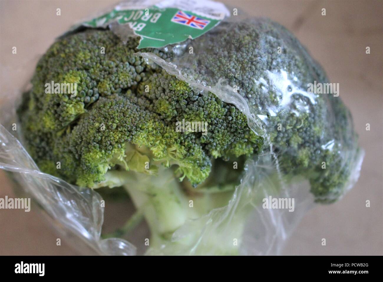 Broccoli wrapped in plastic Stock Photo - Alamy