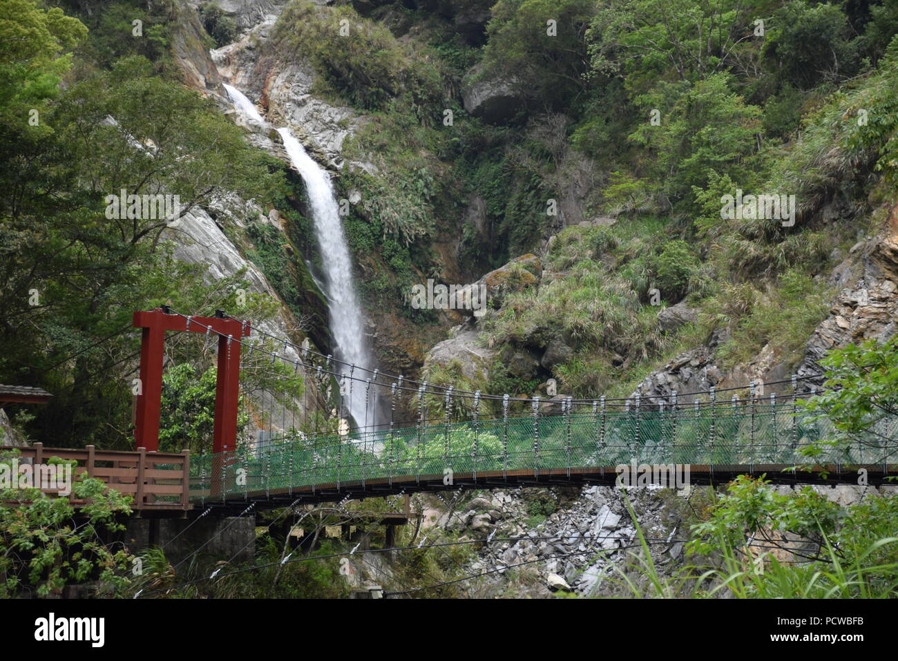 Pedestrian bridge and waterfall inside Taroko National Park in Hualien ...