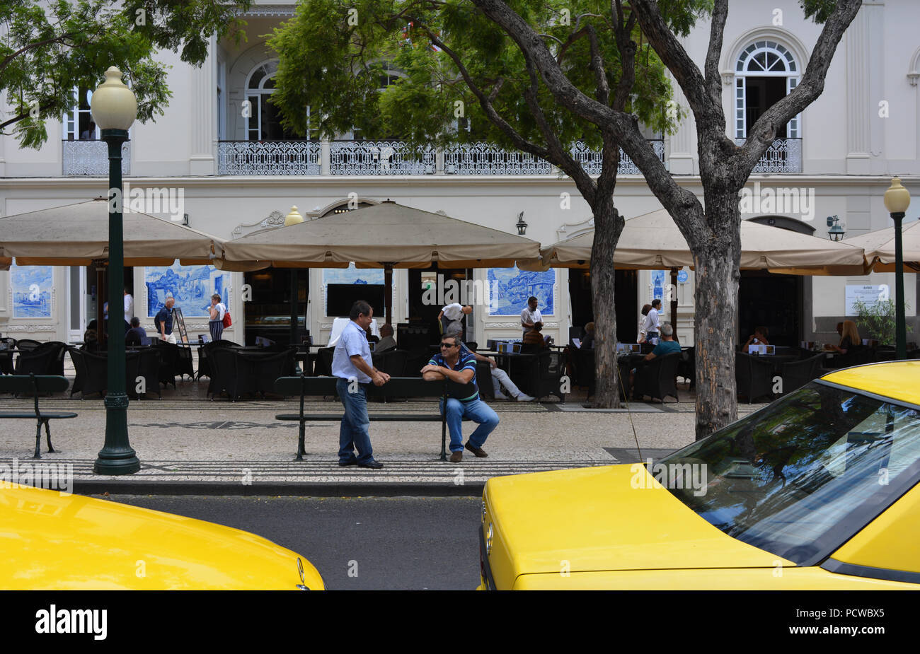 View across Avenida Arriaga with two taxis and two men talking to The ...