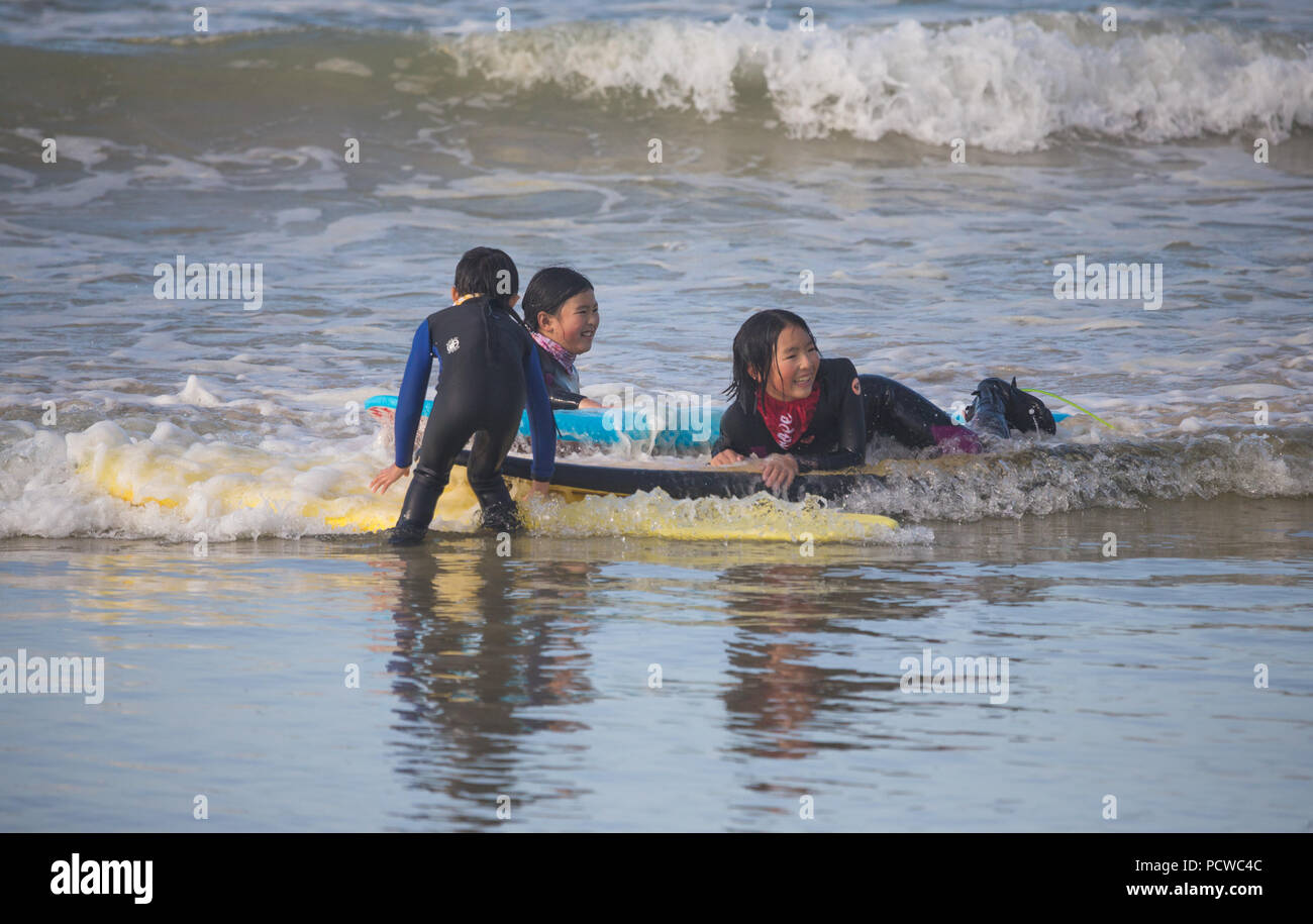 Children playing in the waves hi-res stock photography and images - Alamy