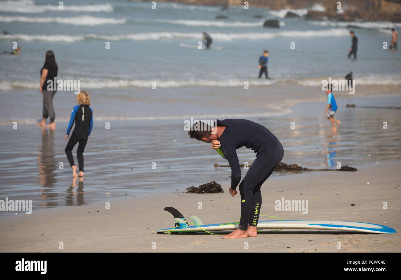 Taking off wetsuit hi-res stock photography and images - Alamy