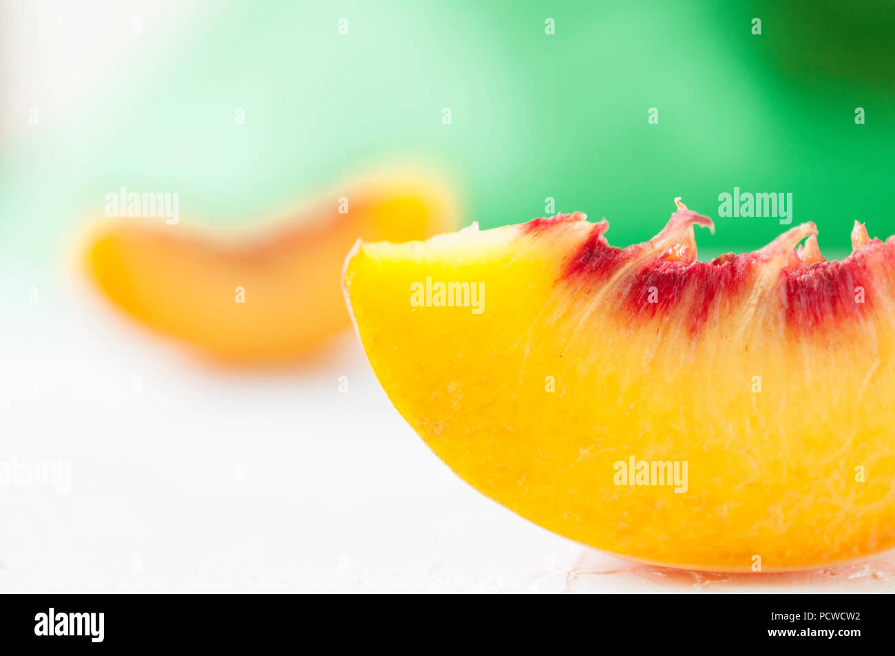 Slice of peach close up shot Stock Photo - Alamy