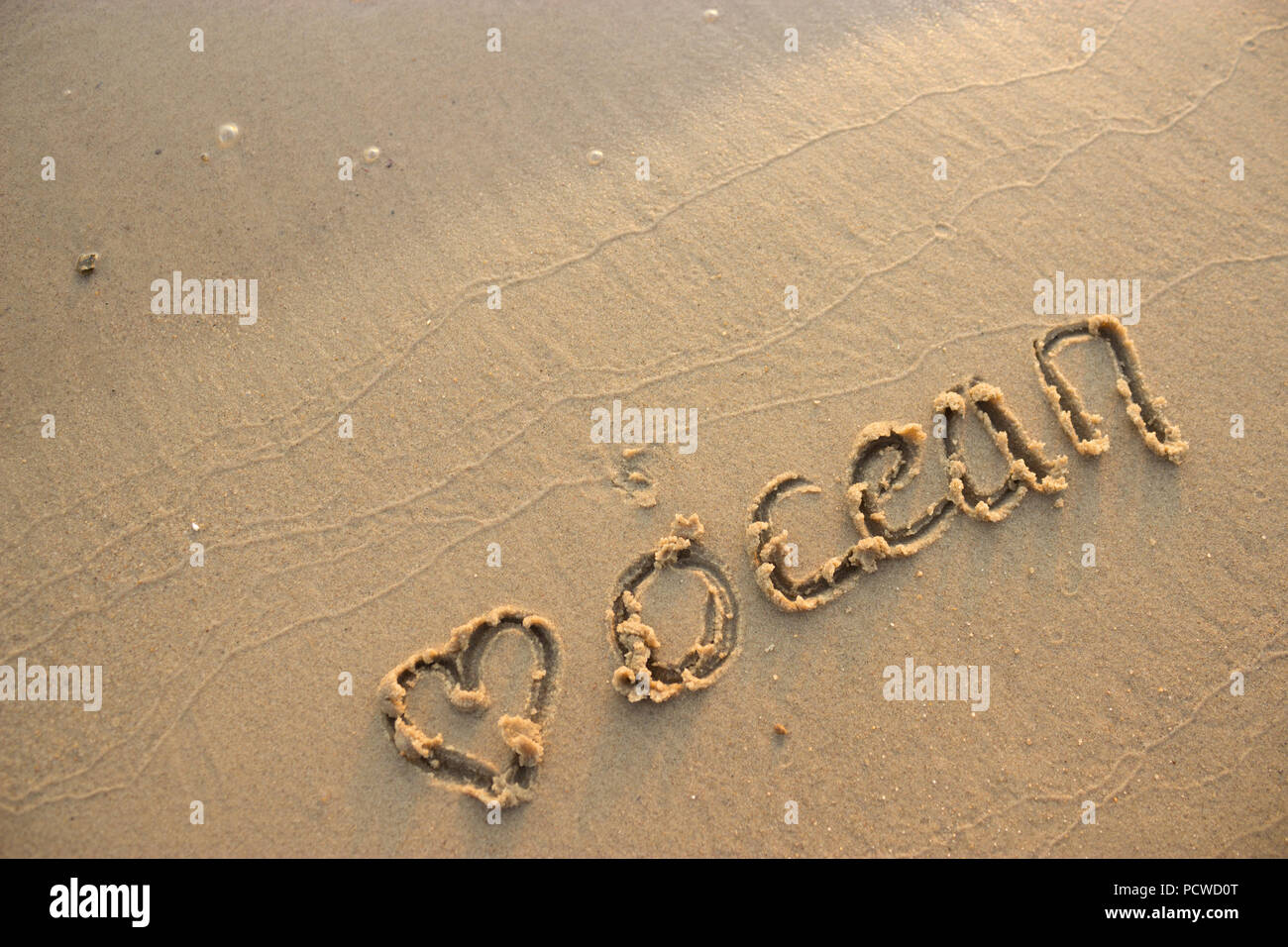 Heart Symbol On a Sand Of Beach. love to ocean concept Stock Photo - Alamy