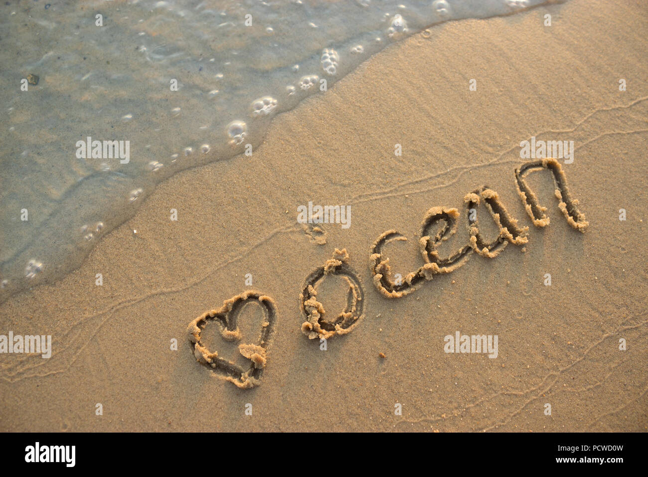 Heart Symbol On a Sand Of Beach. love to ocean concept Stock Photo - Alamy