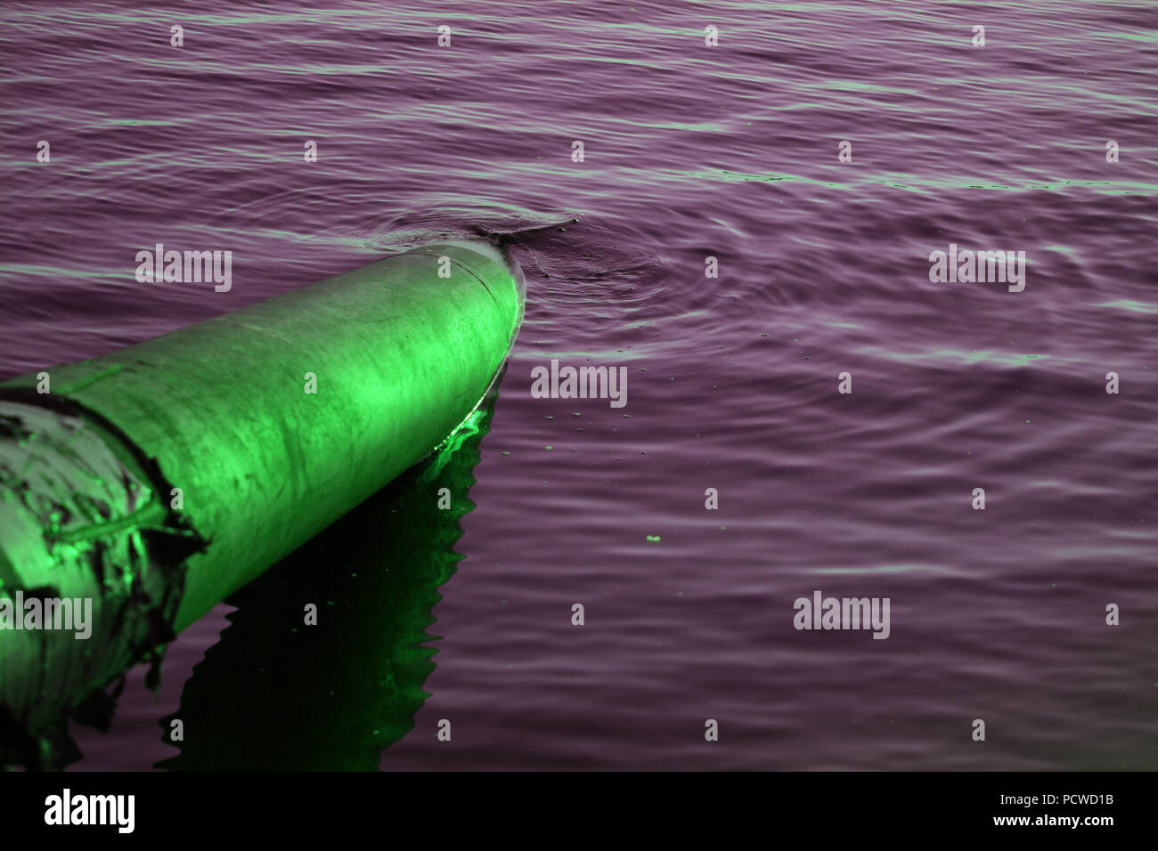 water pollution concept. pipe and toxic green color water Stock Photo ...