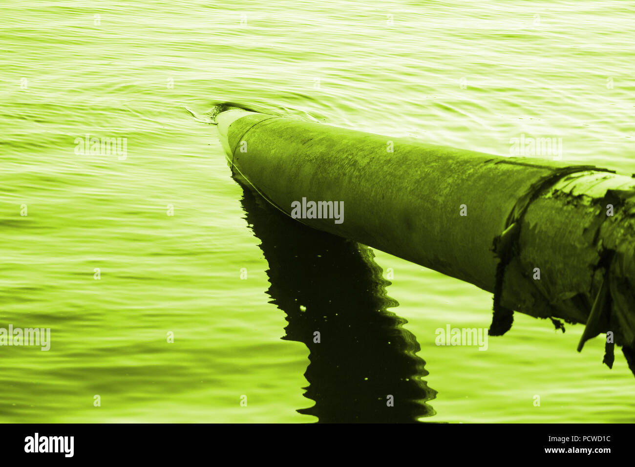 water pollution concept. pipe and toxic green color water Stock Photo ...