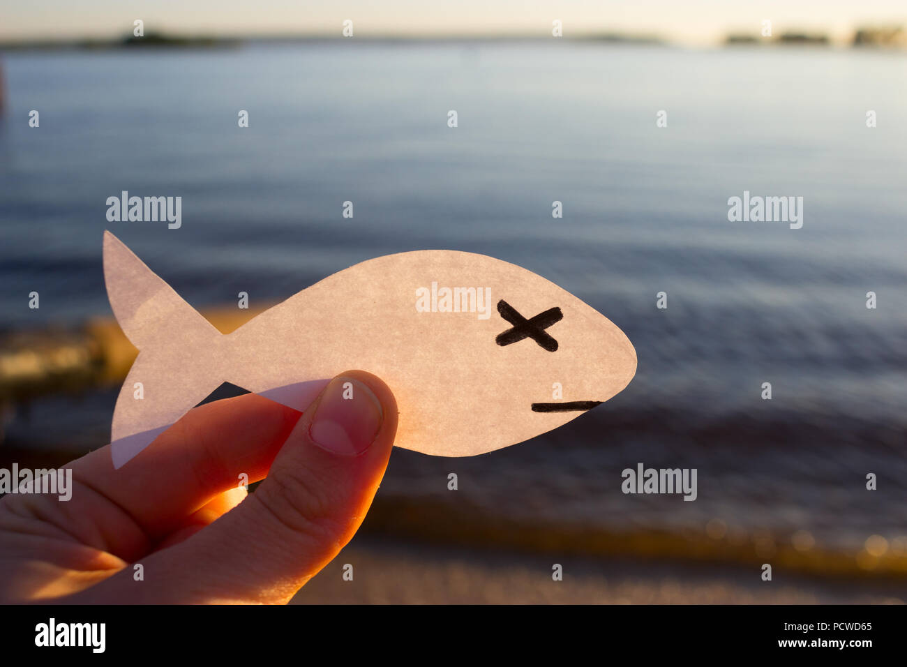 water pollution concept. dead cartoon paper fish Stock Photo - Alamy