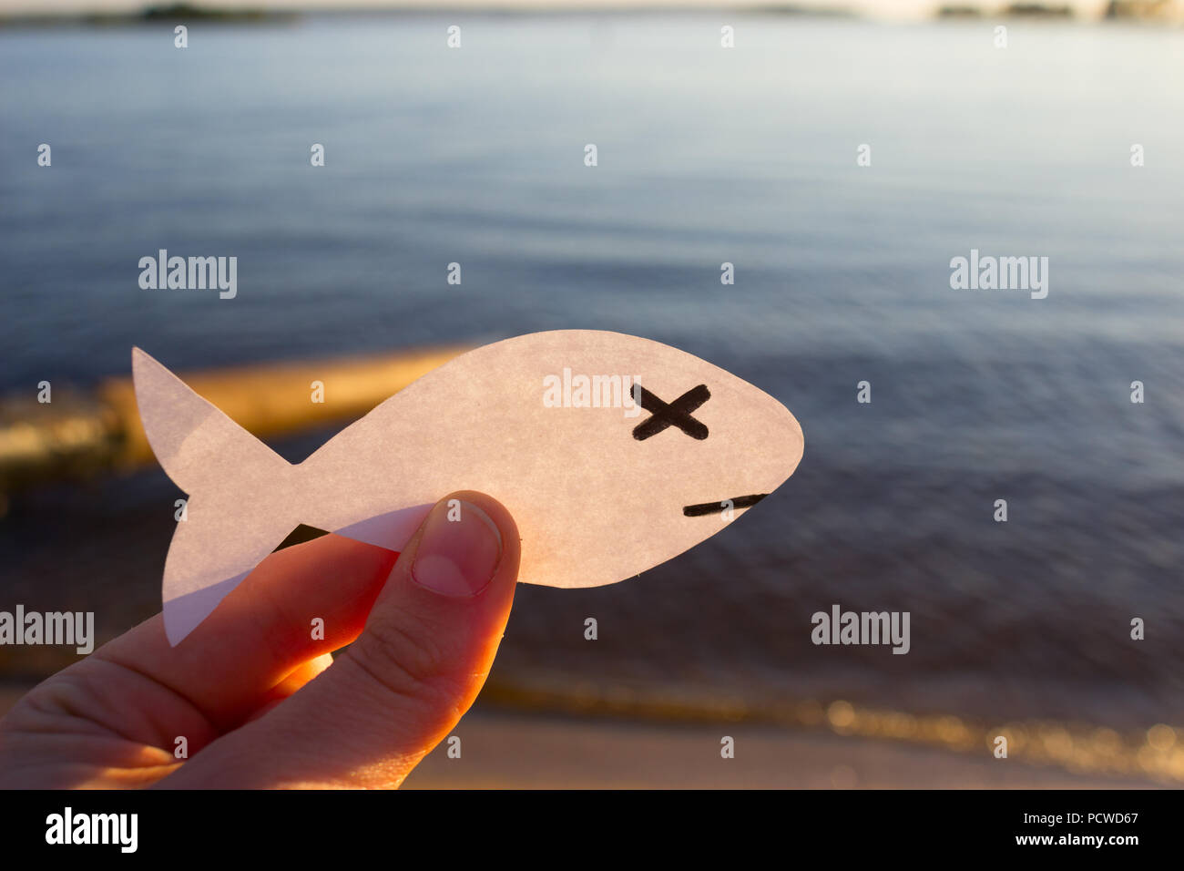 water pollution concept. dead cartoon paper fish Stock Photo - Alamy
