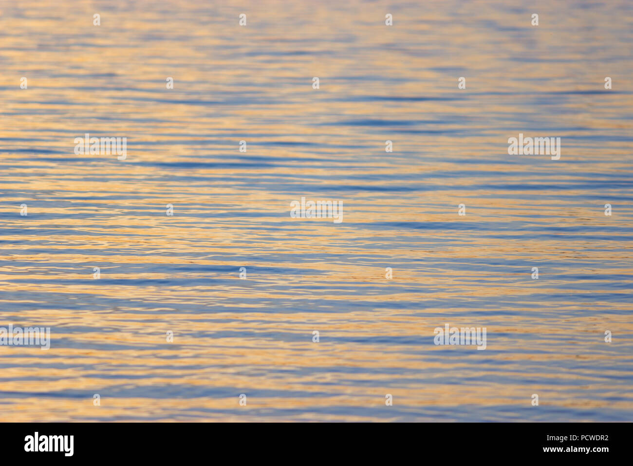 close-up texture of water, bronze waves at sunset Stock Photo - Alamy