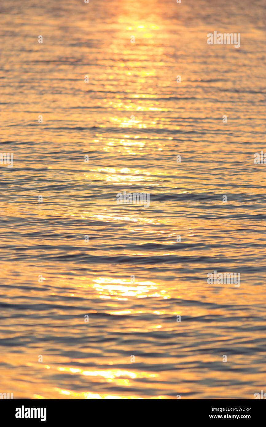 close-up texture of water, bronze waves at sunset Stock Photo - Alamy