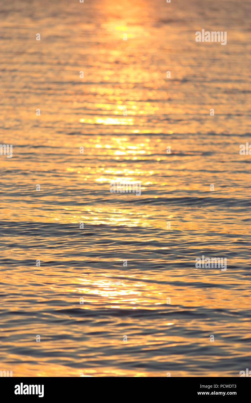 close-up texture of water, bronze waves at sunset Stock Photo - Alamy
