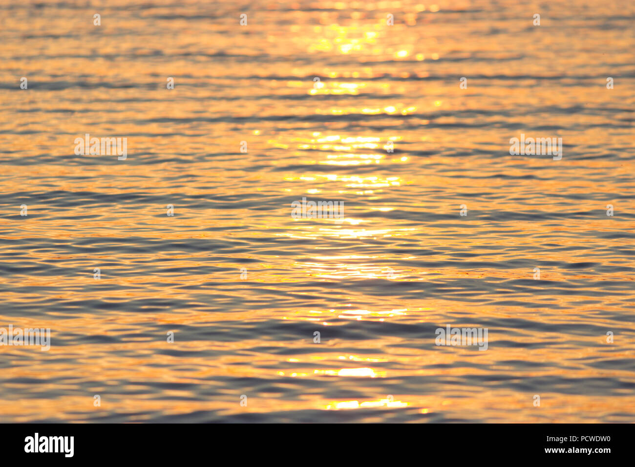 close-up texture of water, bronze waves at sunset Stock Photo - Alamy