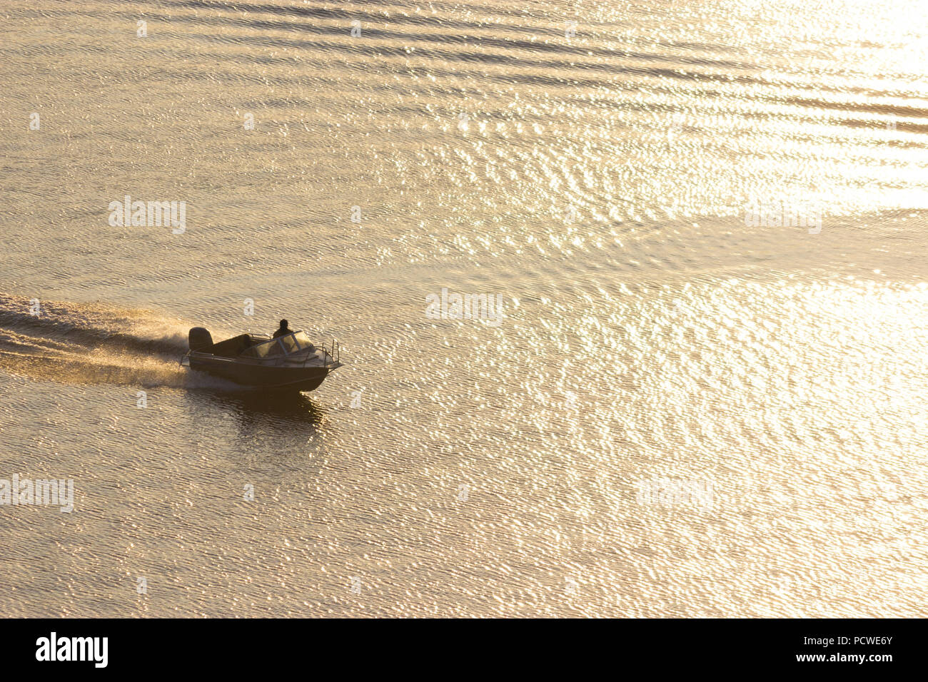 small boat in the river in sunset light Stock Photo - Alamy