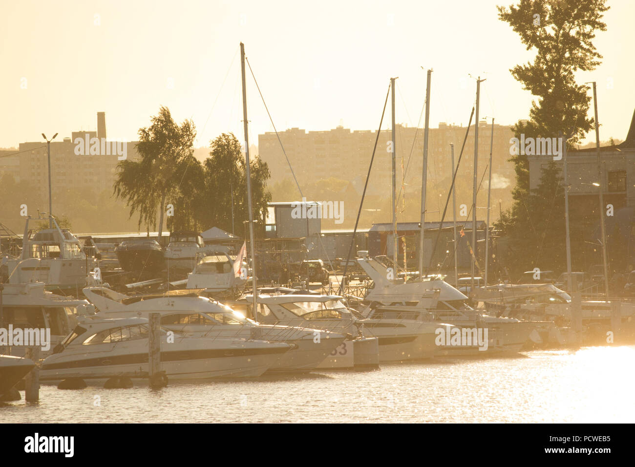marine with motor and sail boats in sunset light Stock Photo - Alamy