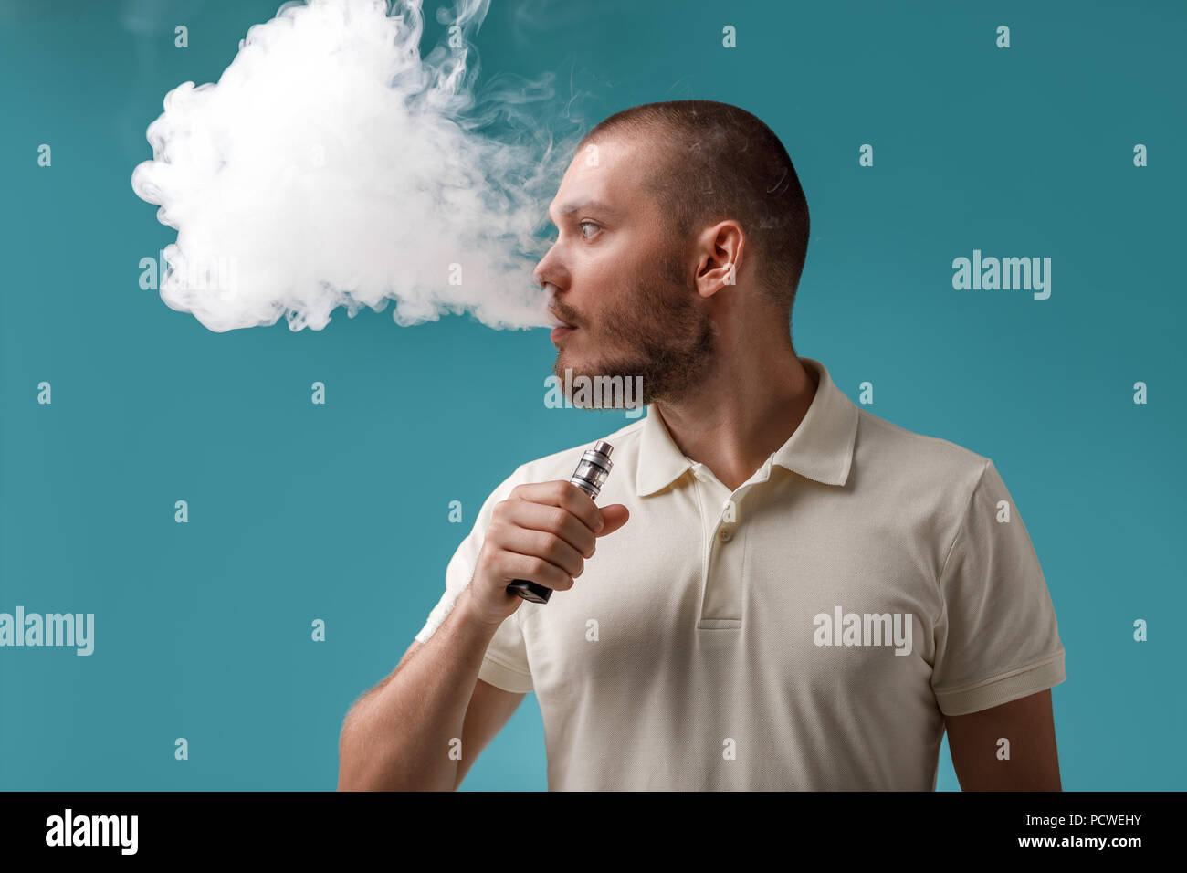 vaping man launches ring of the smoke Stock Photo - Alamy