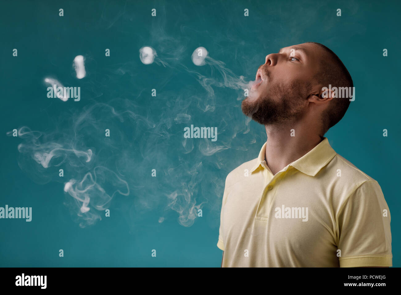 vaping man launches ring of the smoke Stock Photo - Alamy