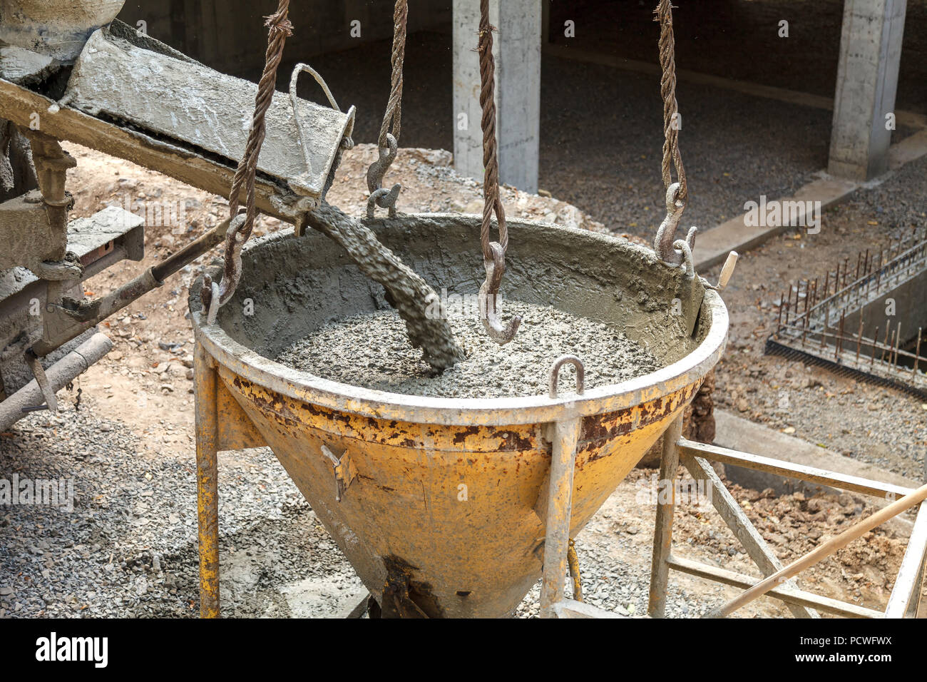 Pouring concrete into the construction of the house. Builders are ...