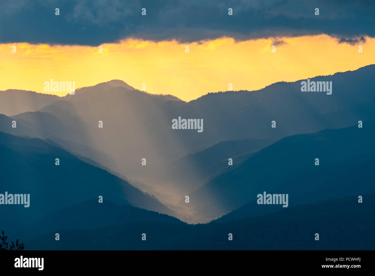 Yellow Sky and Blue Ridge Mountains with rays shining down Stock Photo ...